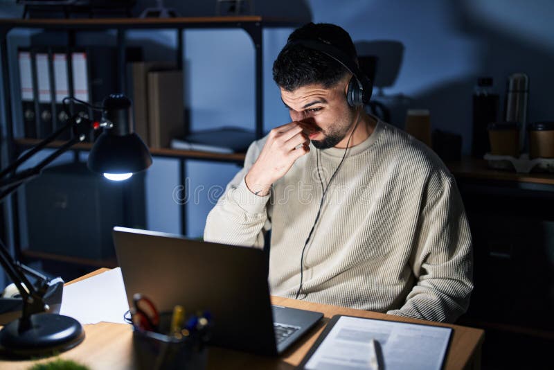 Young Handsome Man Working Using Computer Laptop at Night Smelling ...