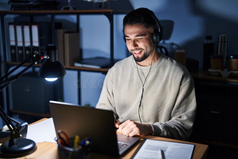 Young Handsome Man Working Using Computer Laptop at Night Winking ...