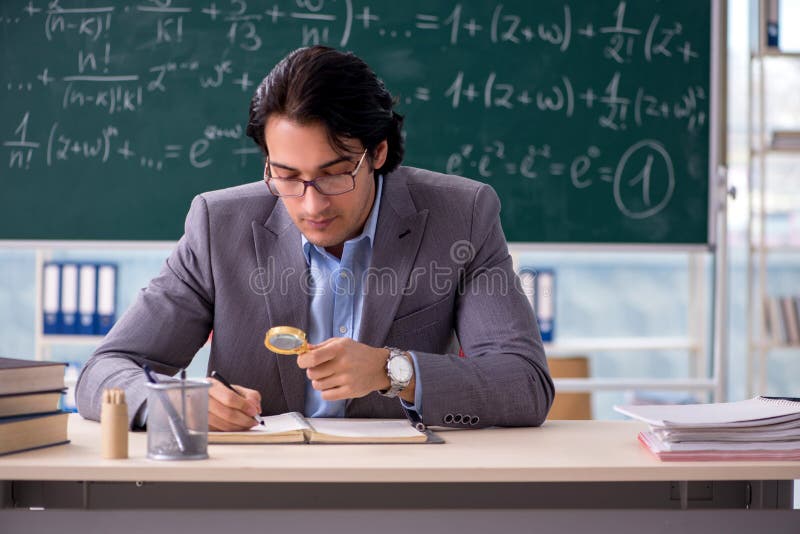 The Young Handsome Math Teacher in Classroom Stock Image - Image of ...