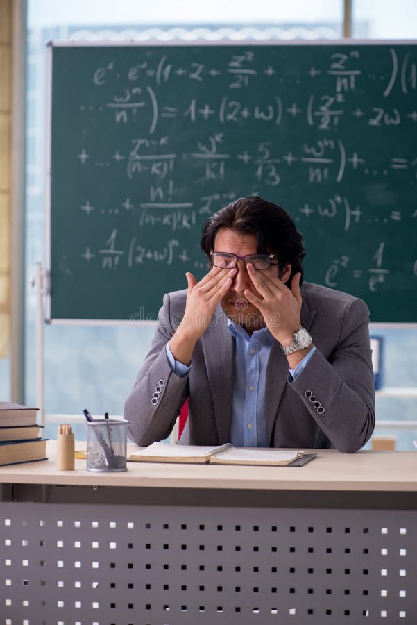 The Young Handsome Math Teacher in Classroom Stock Photo - Image of ...