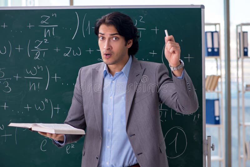 The Young Handsome Math Teacher in Classroom Stock Photo - Image of ...