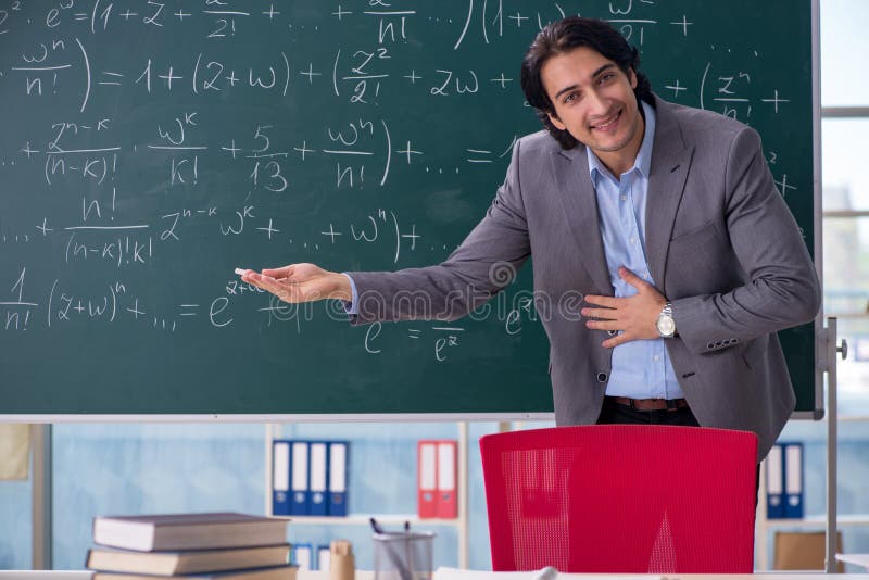 The Young Handsome Math Teacher in Classroom Stock Photo - Image of ...