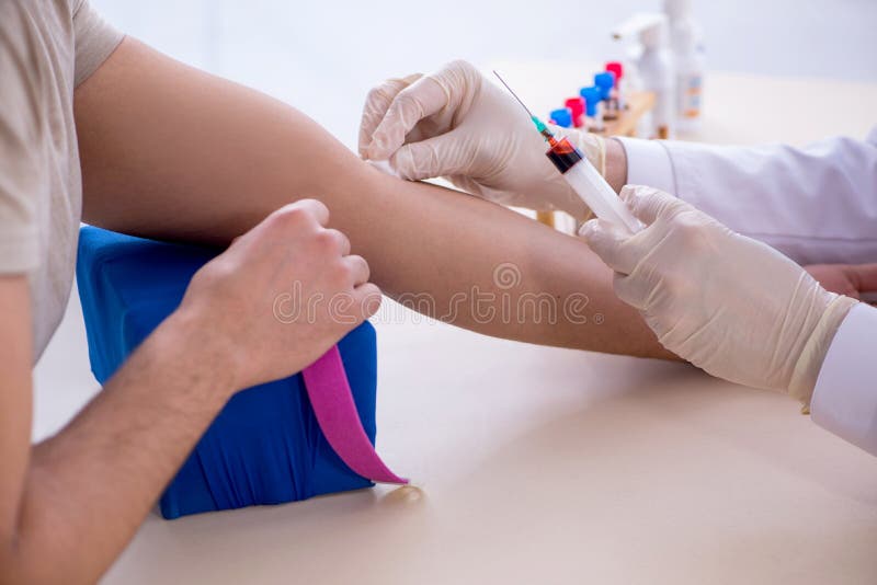 Young Handsome Man during Blood Test Sampling Procedure Stock Photo ...