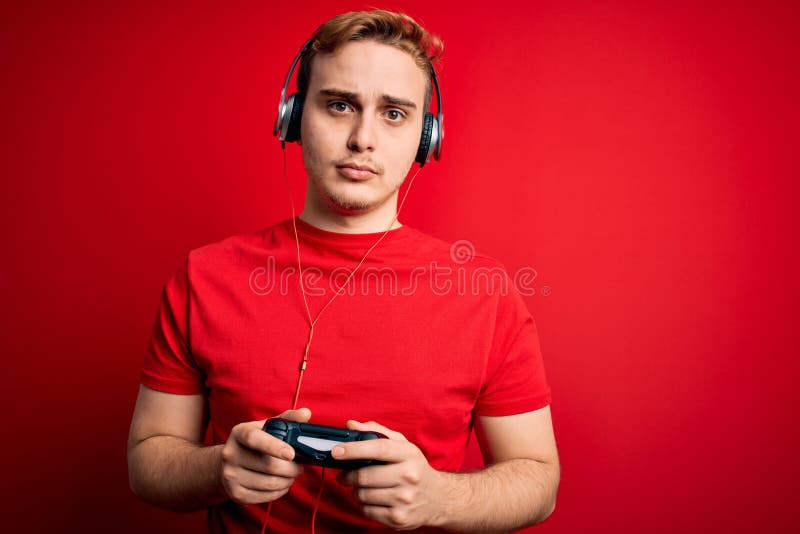 Young Handsome Redhead Gamer Man Playing Video Game Using Headphones ...