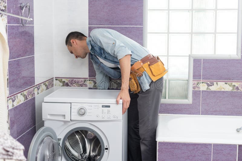 The Young Handsome Repairman in Worker Suit with the Professional Tools ...