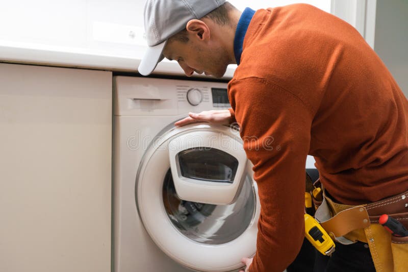 The Young Handsome Repairman in Worker Suit with the Professional Tools ...