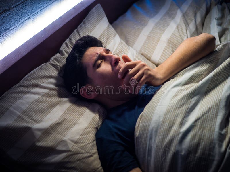 Young Handsome Sleepy Man in Bed Waking Up Stock Photo - Image of ...