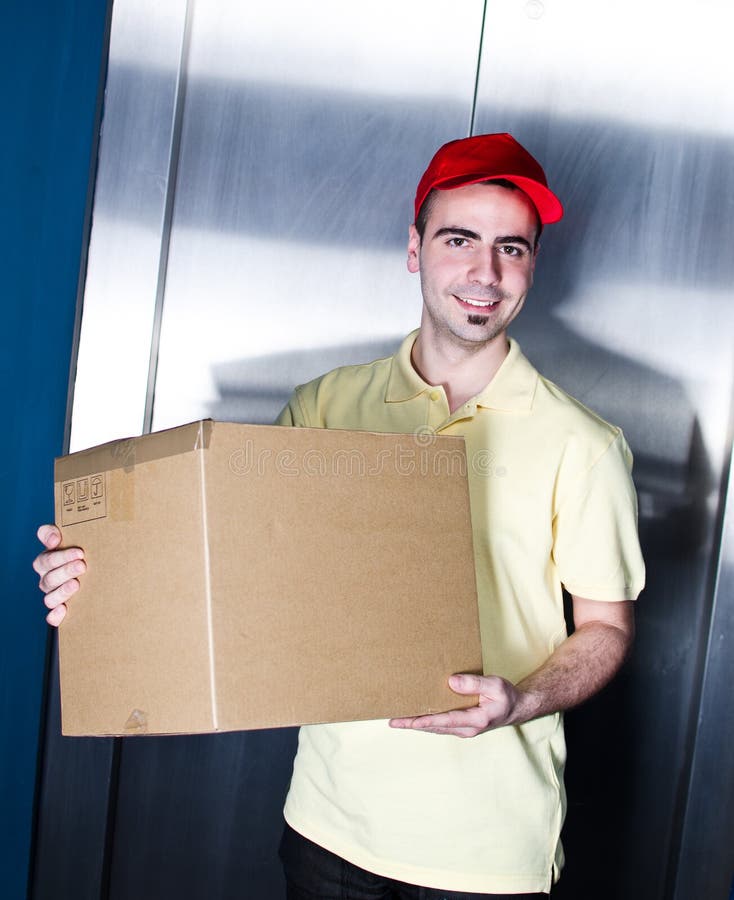 Young Handsome Smiling Delivery Man with Box Stock Photo - Image of ...