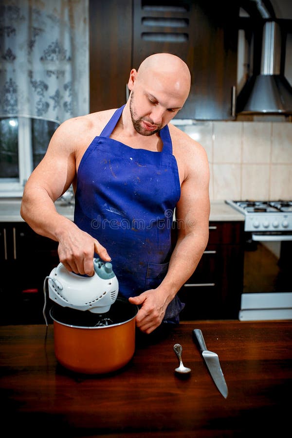 A Young Man is Cooking in a Large Kitchen Stock Image - Image of people ...