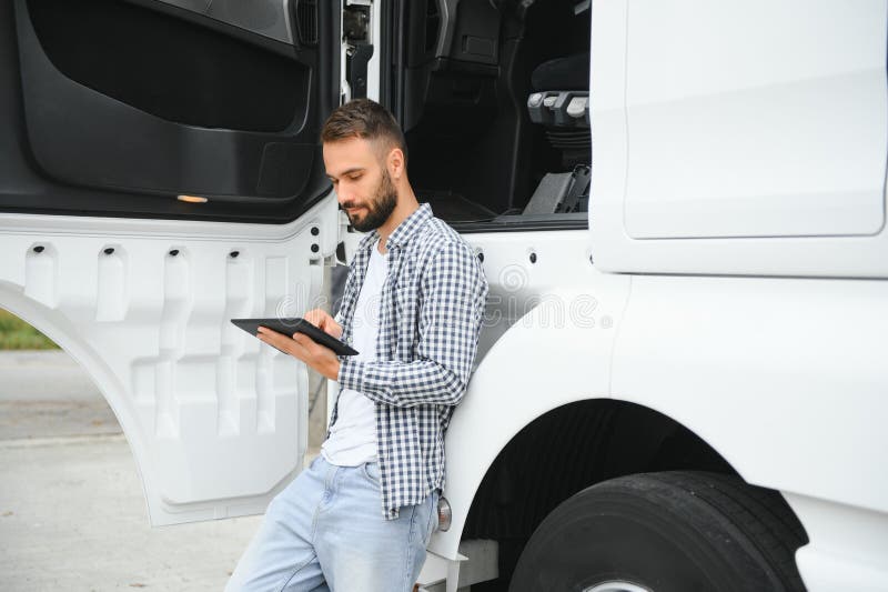 Young Handsome Truck Driver is Standing with a Tablet Near the Truck ...