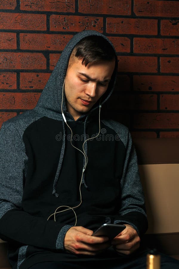 Young Handsome White Guy is Typing Sms on His Phone. Stock Photo ...