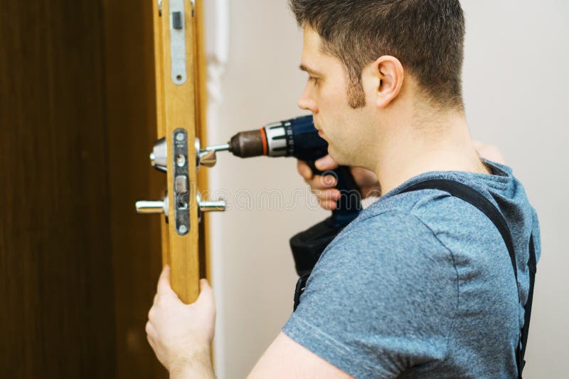 Man changing door lock stock image. Image of locksmith - 134290181