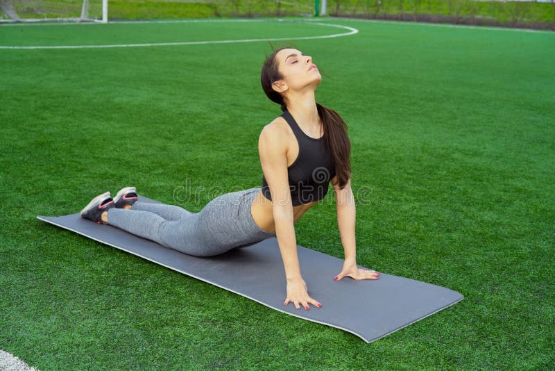 Young Happy And Beautiful Brunette Girl Doing Yoga Workout In Park