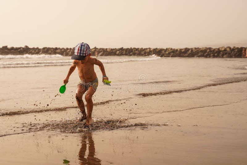 Young Happy Boy Jumping into the Air on Beach Stock Photo - Image of ... Young Happy Boy Jumping into the Air on Beach Stock Photo - Image of ...