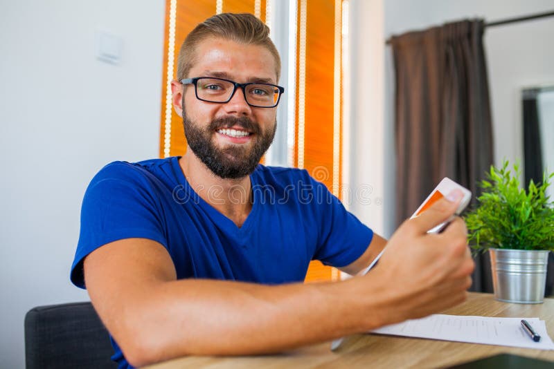 Young Happy Businessman Sitting Behind Table with Tablet Pc in H Stock ...