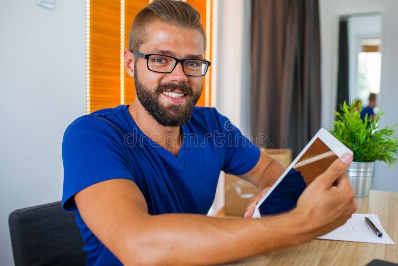 Young Happy Businessman Sitting Behind Table with Tablet Pc in H Stock ...
