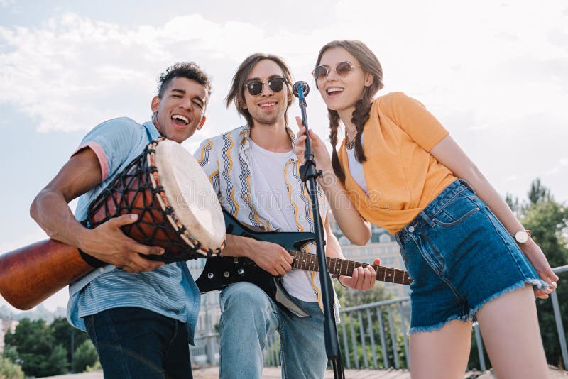 Young Happy Buskers Singing by Microphone Stock Photo - Image of guitar ...