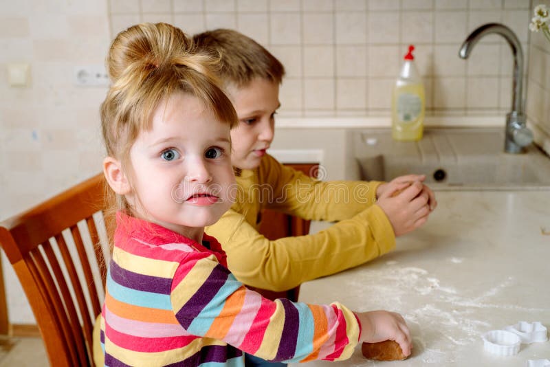 Young Happy Children Kids Having Fun Preparing a Cake in Kitchen at ...