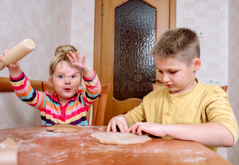 Young Happy Children Kids Having Fun Preparing a Cake in Kitchen at ...