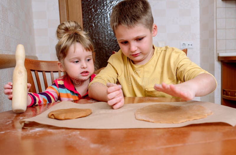 Young Happy Children Kids Having Fun Preparing a Cake in Kitchen at ...