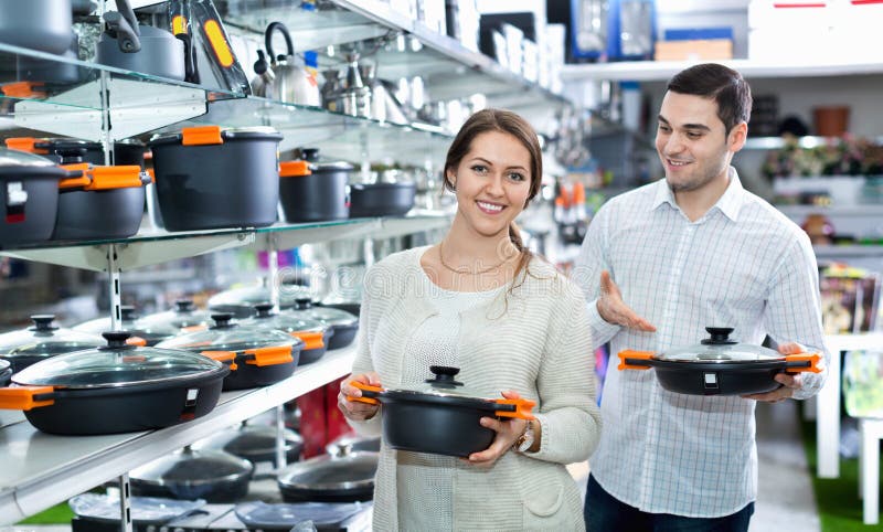 Young Happy Couple in the Cookware Section Stock Image - Image of cover ...