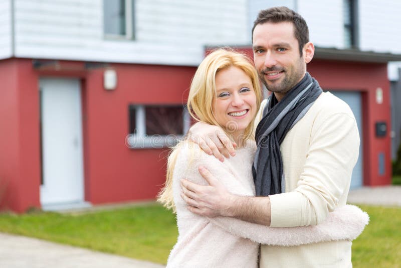 Young Happy Couple in Front of Their New House Stock Image - Image of ...