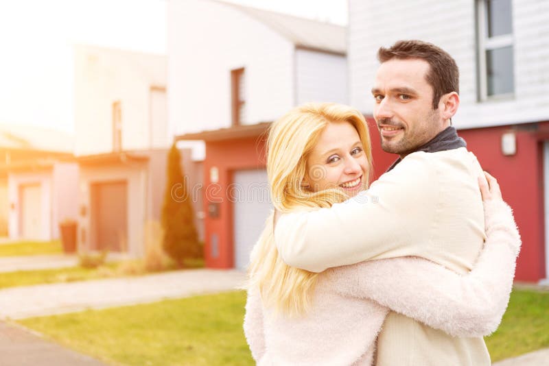 Young Happy Couple in Front of Their New House Stock Image - Image of ...