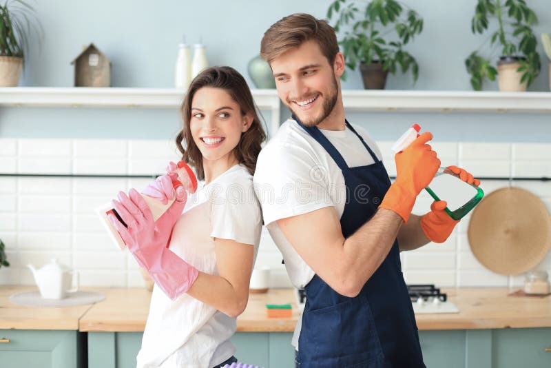 Young Happy Couple is Having Fun while Doing Cleaning at Home Stock ...