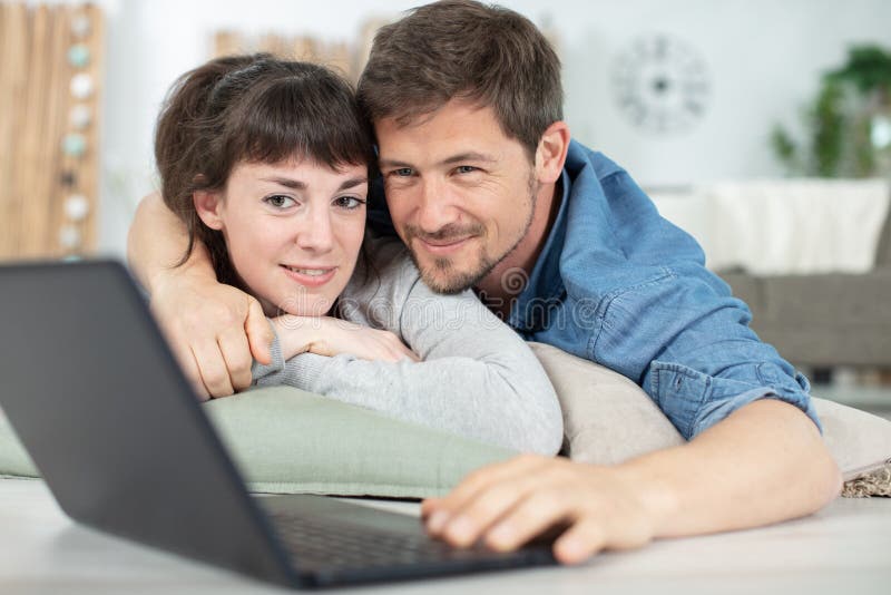 Young Happy Couple Hugging and Using Pc Stock Photo - Image of movie ...