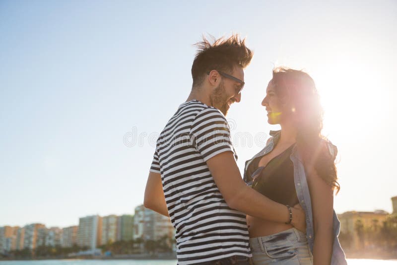 Young Happy Couple Looking at Each Other Outside Stock Photo - Image of ...