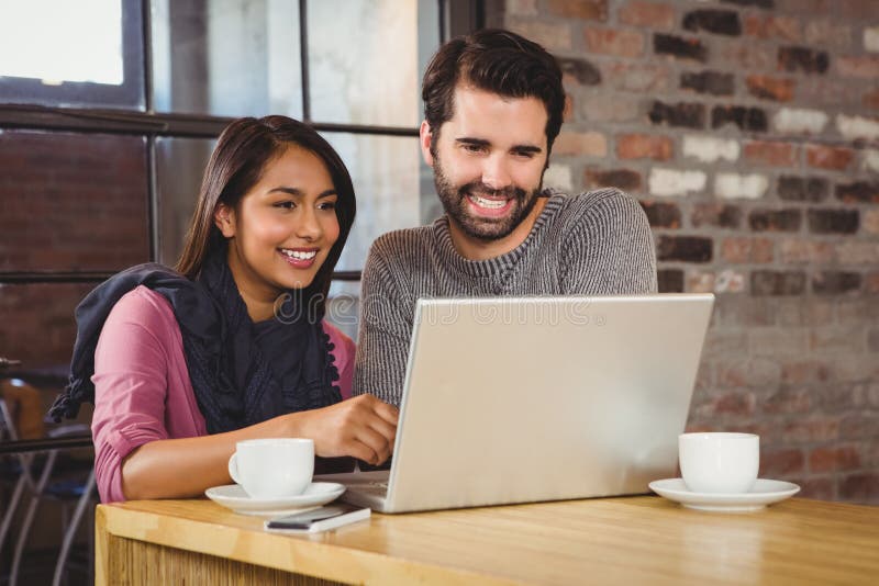 Young Happy Couple Looking at a Laptop Stock Image - Image of cheerful ...