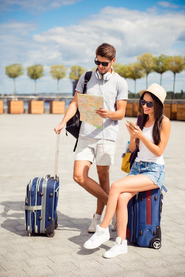 Young Happy Couple on a Sightseeing Tour Reading Map Stock Photo ...