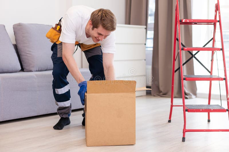 Young Happy Delivery Man Unloading Boxes. Stock Photo - Image of ...