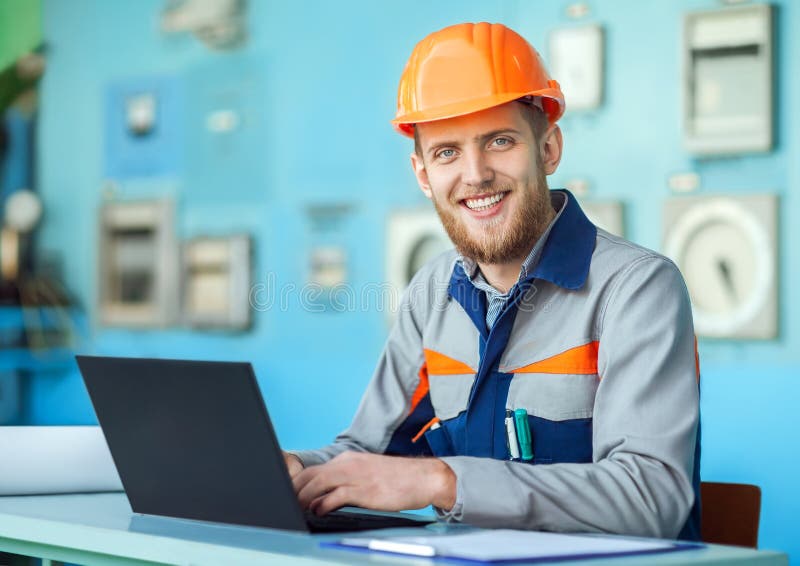 Young Happy Engineer Working at Laptop in Control Room Stock Photo ...