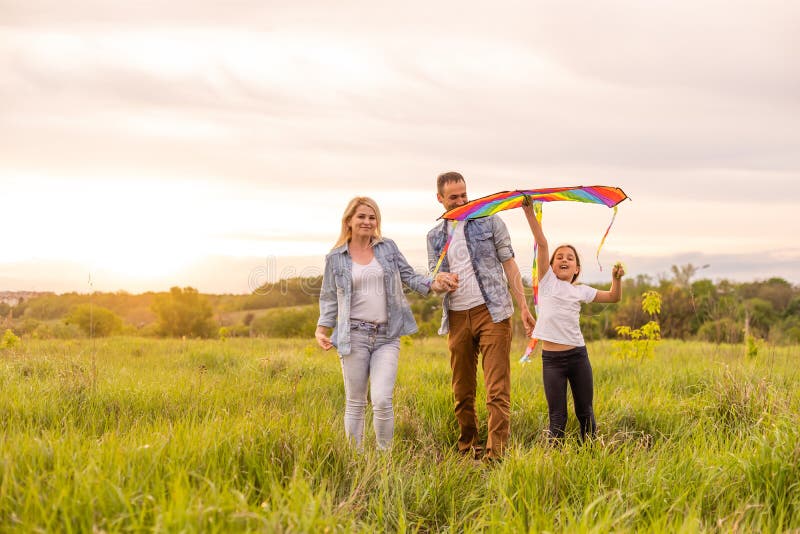Young Happy Family in a Field Stock Photo - Image of mother, family ...