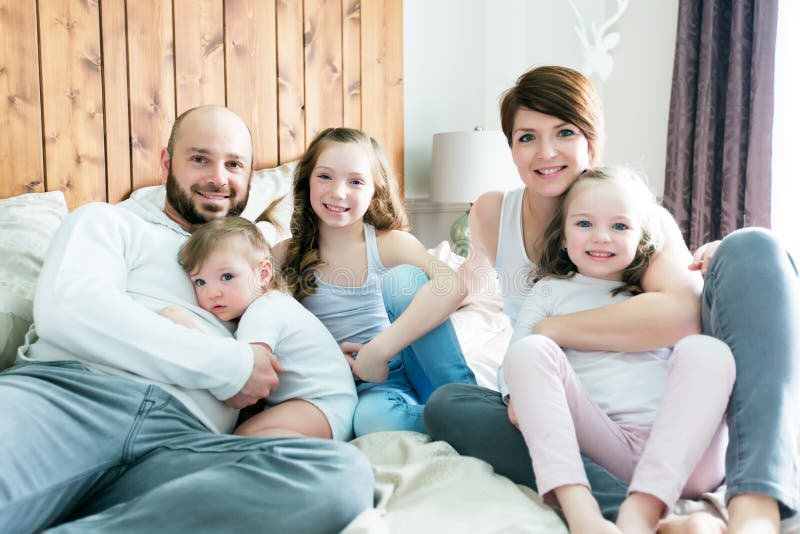 Young Happy Family of Five on Bedroom Stock Image - Image of motherhood ...