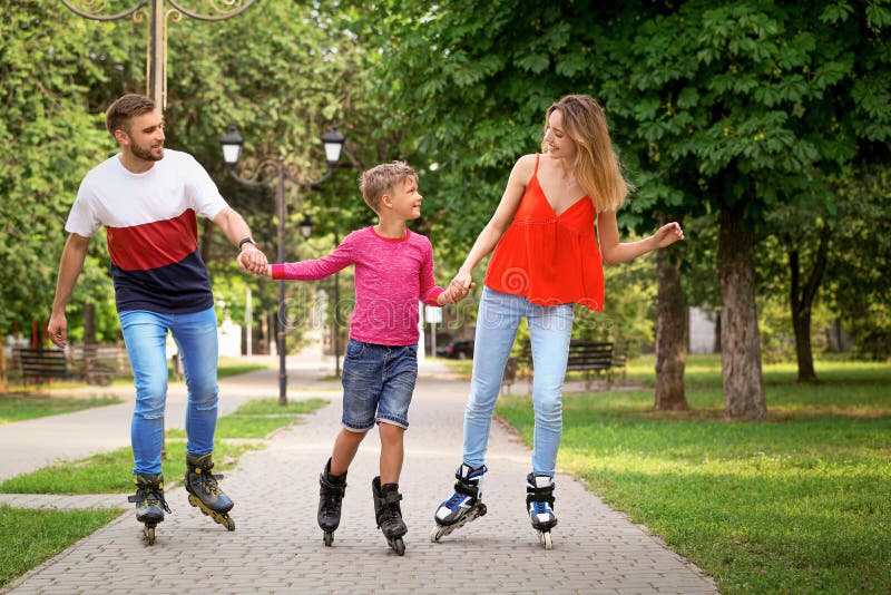 Young Happy Family Roller in Summer Park Stock Photo - Image of parent ...