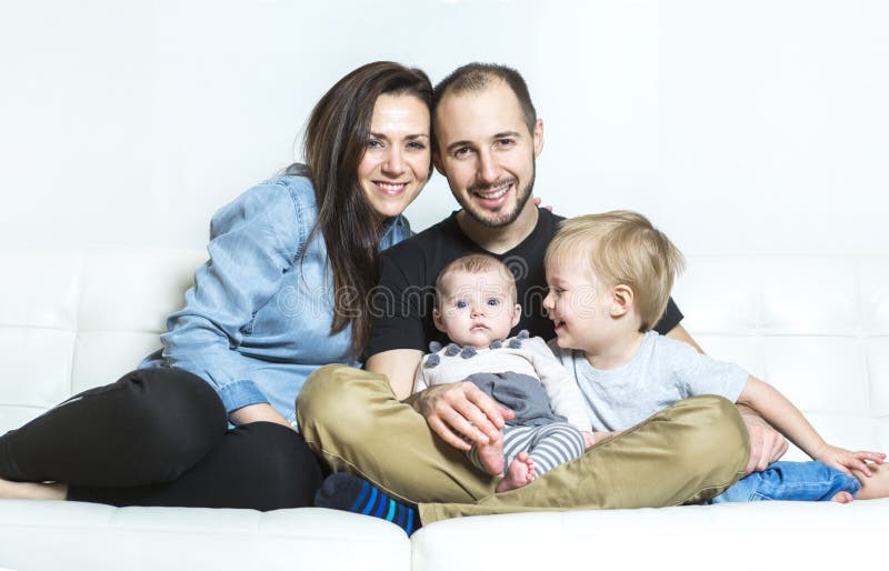 Young Happy Family with Two Children at Home Stock Photo - Image of ...