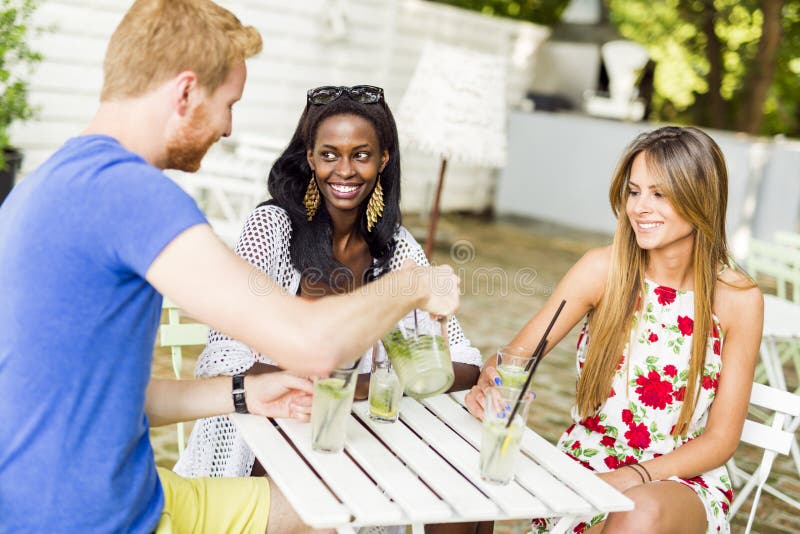 Young and Happy Friends Sitting Talking at a Table Stock Photo - Image ...