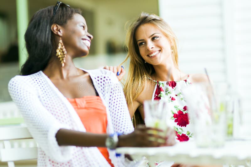 Young and Happy Friends Sitting Talking at a Table Stock Image - Image ...