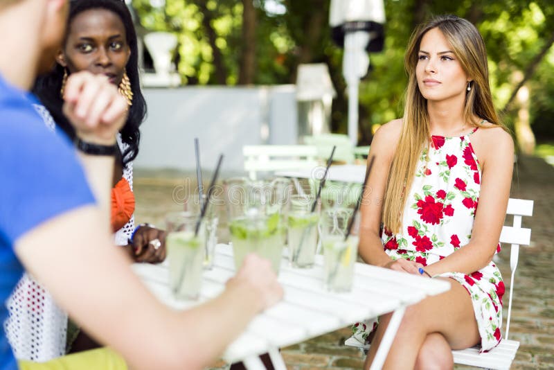 Young and Happy Friends Sitting Talking at a Table Stock Image - Image ...