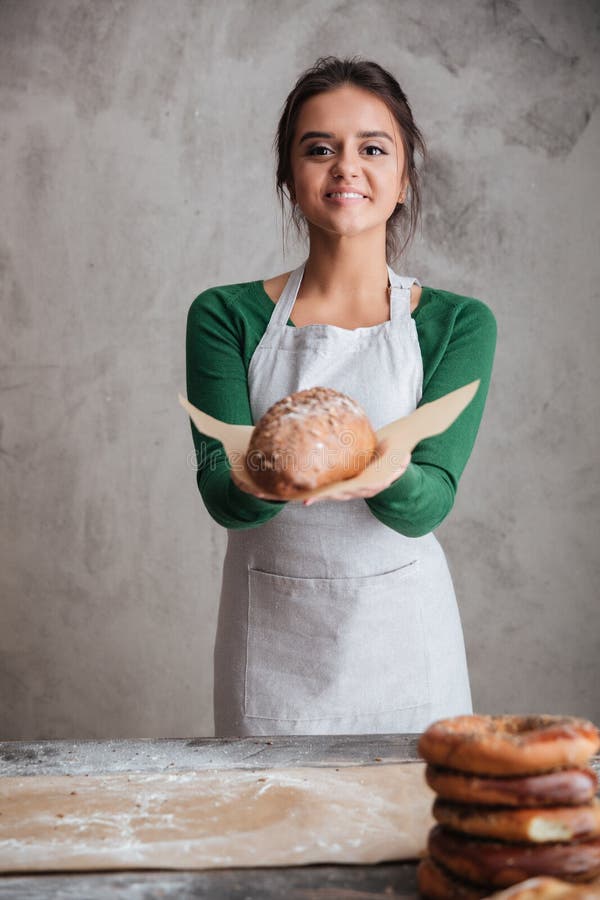 Young Happy Lady Baker Standing and Holding Bread Stock Photo - Image ...