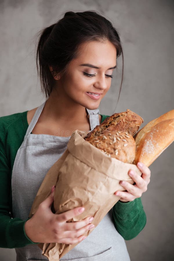 Young Happy Lady Baker Standing and Holding Bread. Stock Photo - Image ...