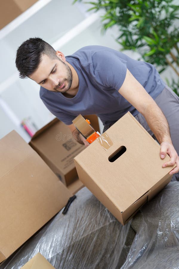 Young Happy Man Packing Boxes Stock Image - Image of happy, sealing ...