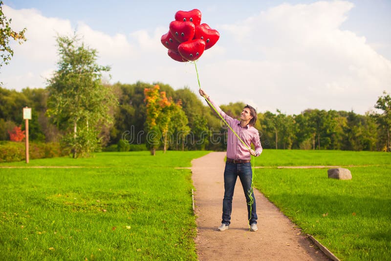Young Happy Man with Red Balloons Walking in the Park Stock Image ...