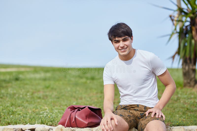 Young Happy Man Sitting Outside with Backpack Stock Image - Image of ...