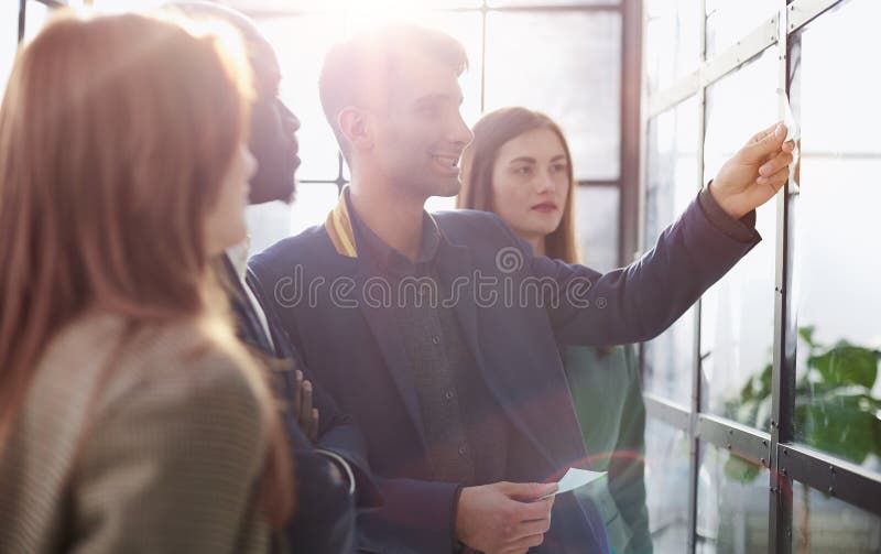 Creative Business Team Looking at Sticky Notes on Glass Window Stock ...