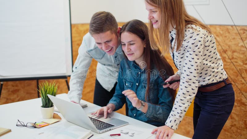 Young People is Working Together Using Laptop and Discussing the ...
