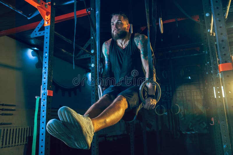 Young Healthy Man Athlete Doing Exercise in the Gym Stock Photo - Image ...