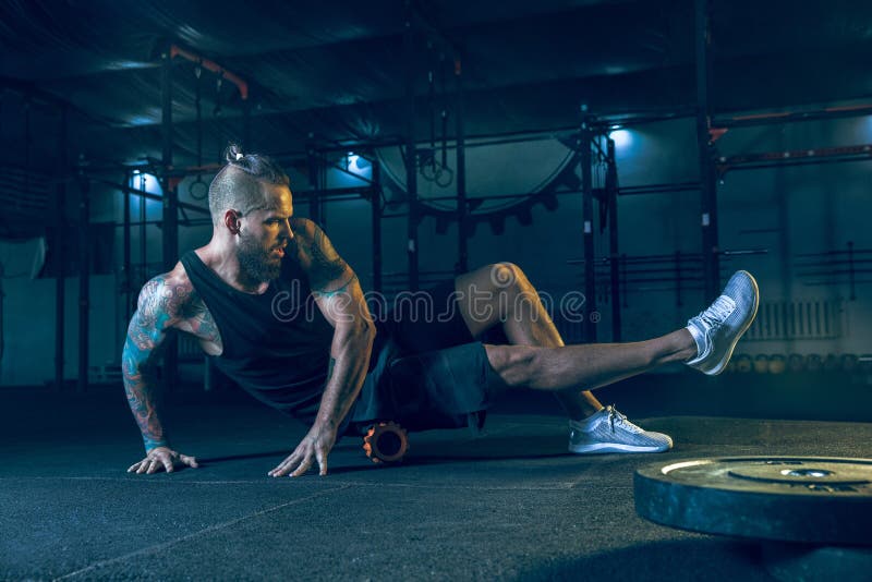 Young Healthy Man Athlete Doing Exercise in the Gym Stock Photo - Image ...